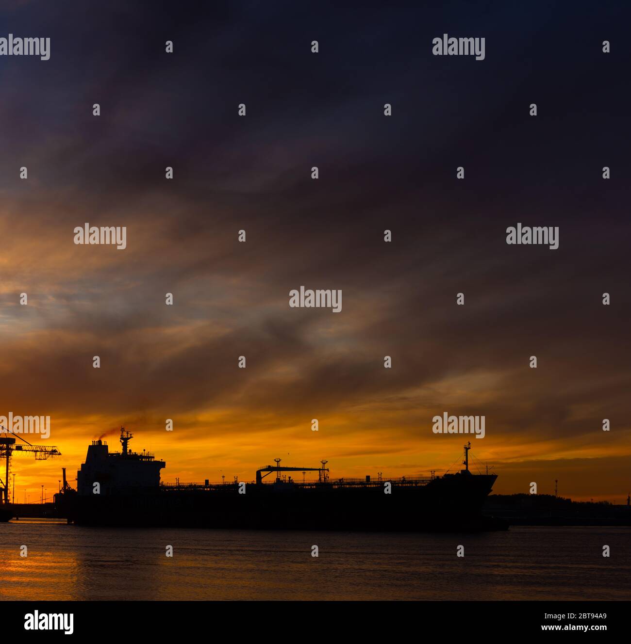 Silhouette of an oil tanker at sunset Stock Photo - Alamy