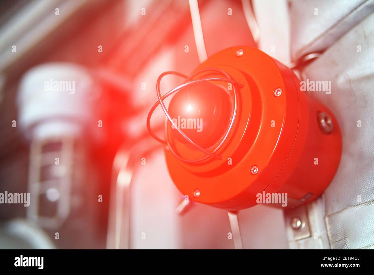 Fire alarm with red warning light of an emergency beacon at an ...