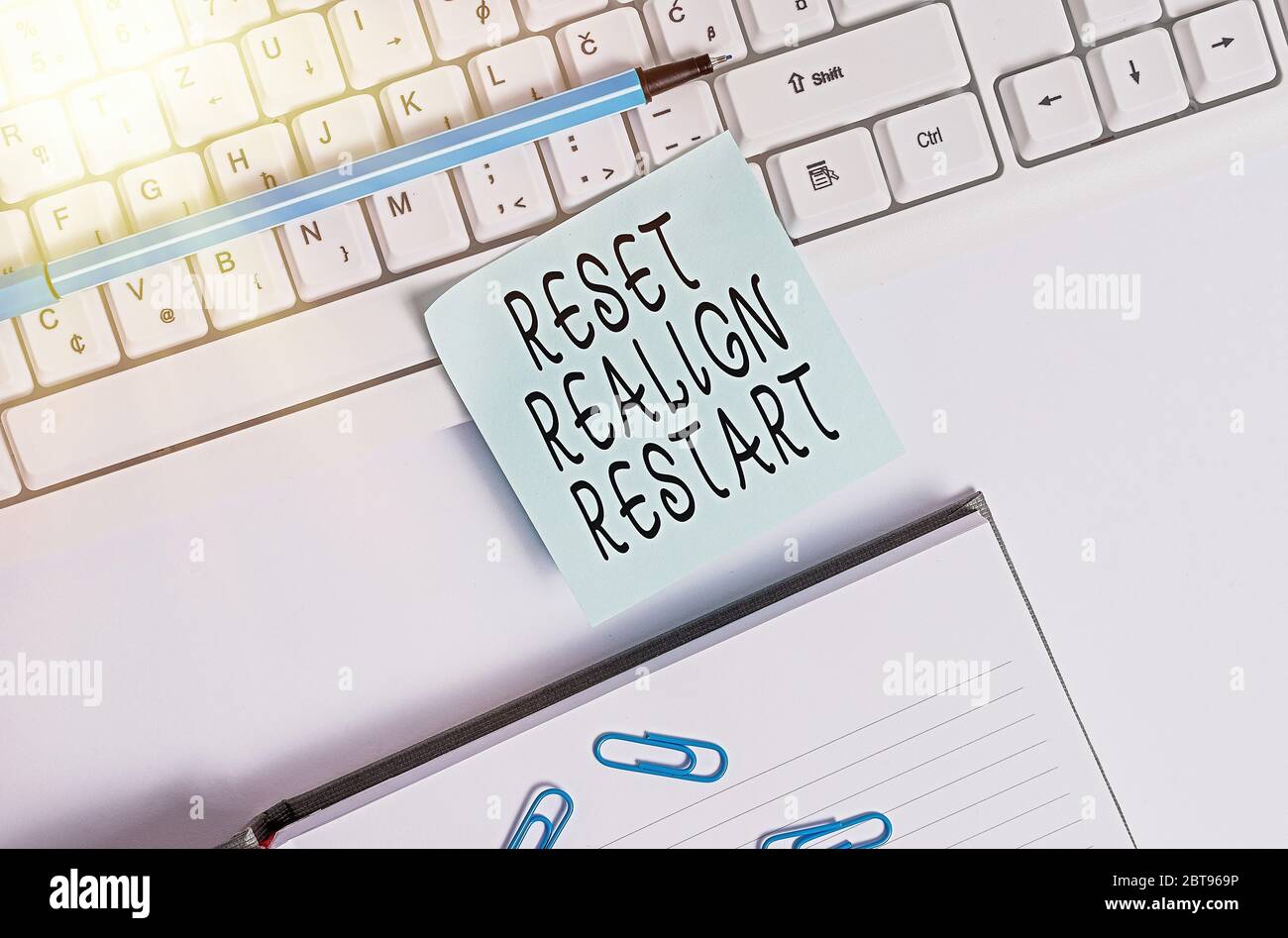 Writing note showing Reset Realign Restart. Business concept for Life ...