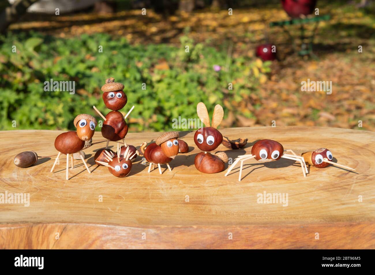 Group of characters or figurines made with chestnuts on a wooden ...