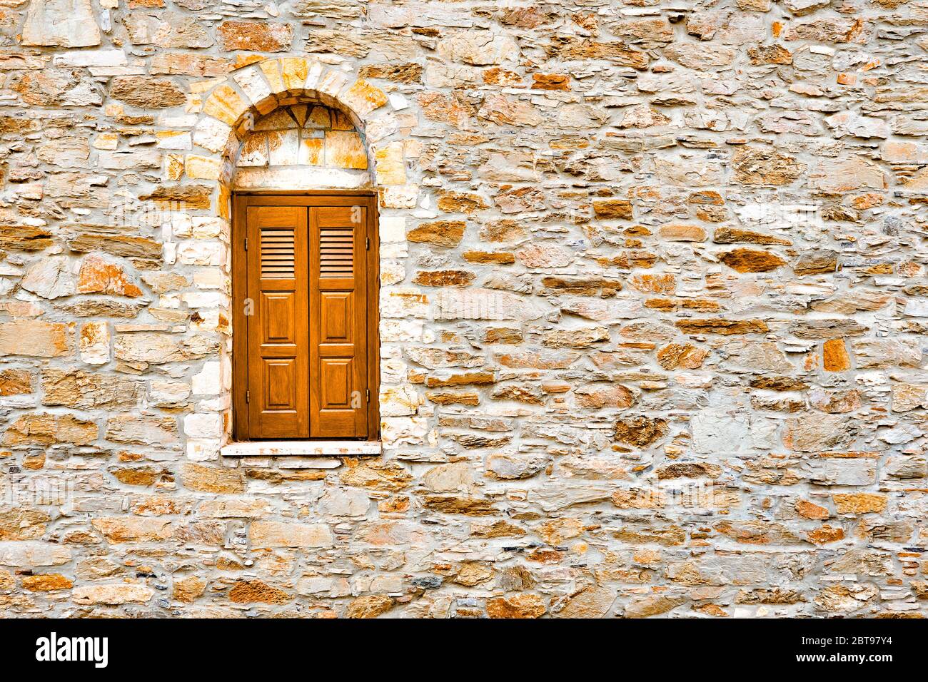 Arch window with stone wall. Wall with window background. Surface with ...