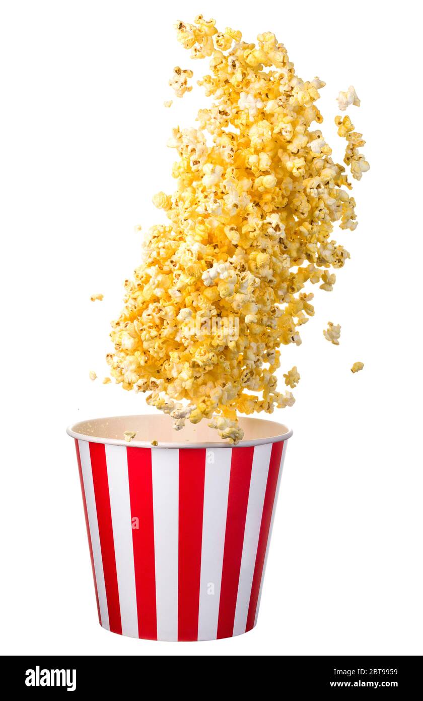 Flying popcorn from paper striped bucket isolated on black background ...