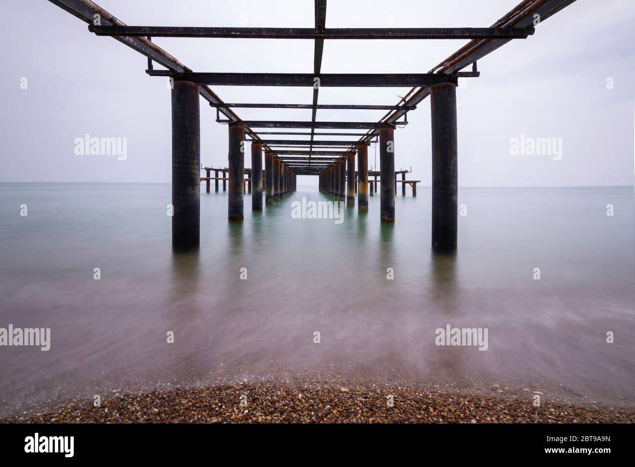 Long exposure sea photo under iron pier Stock Photo - Alamy