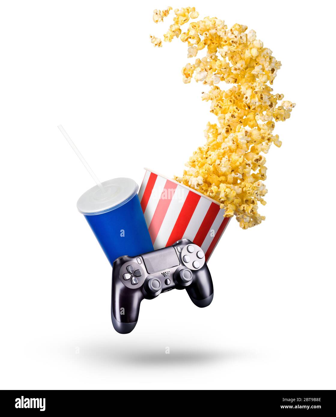 Paper bucket with popcorn, cup of drink and video game joystick on ...
