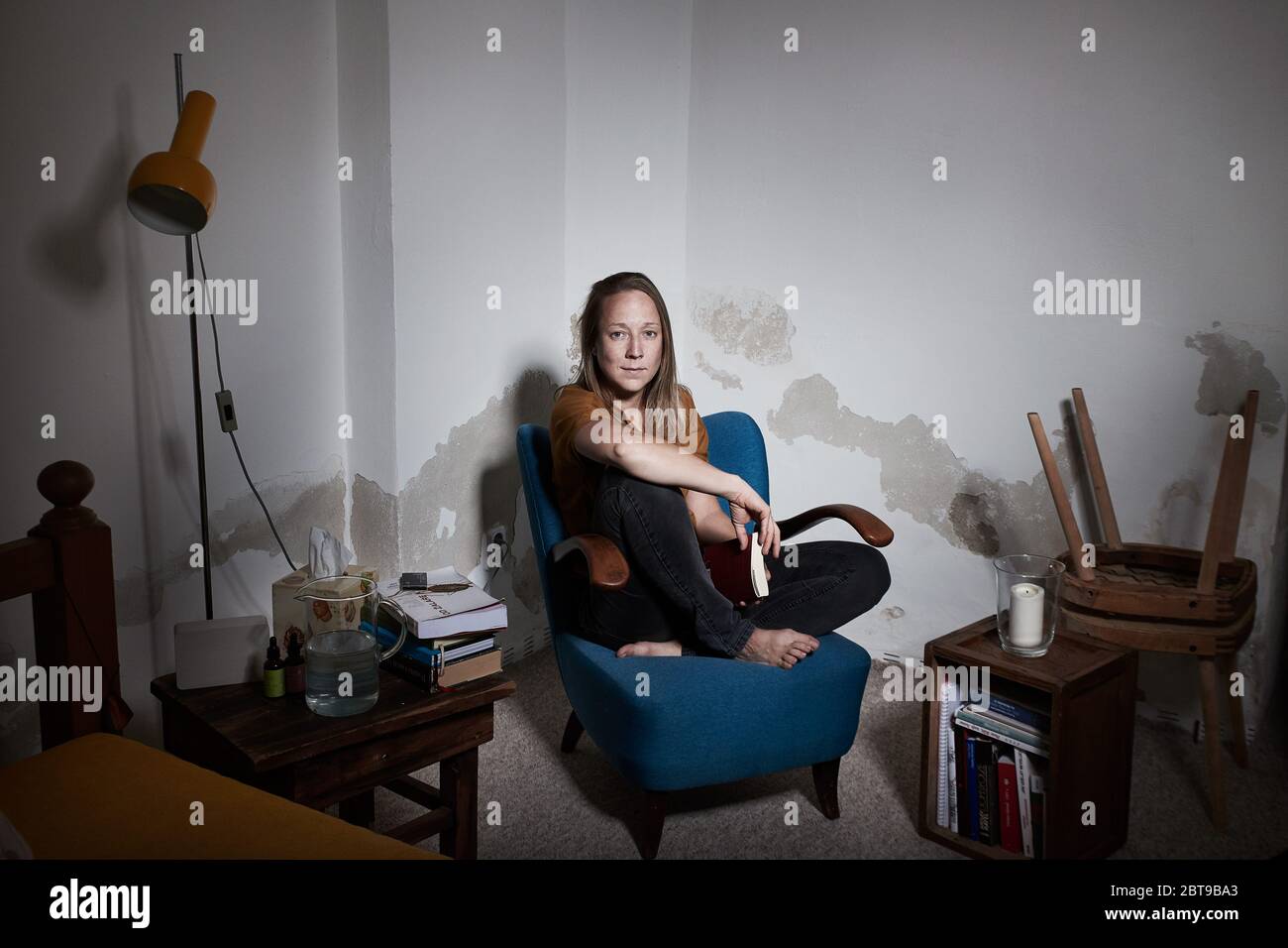 Environmental portrait of a female artist in her basement apartment in ...