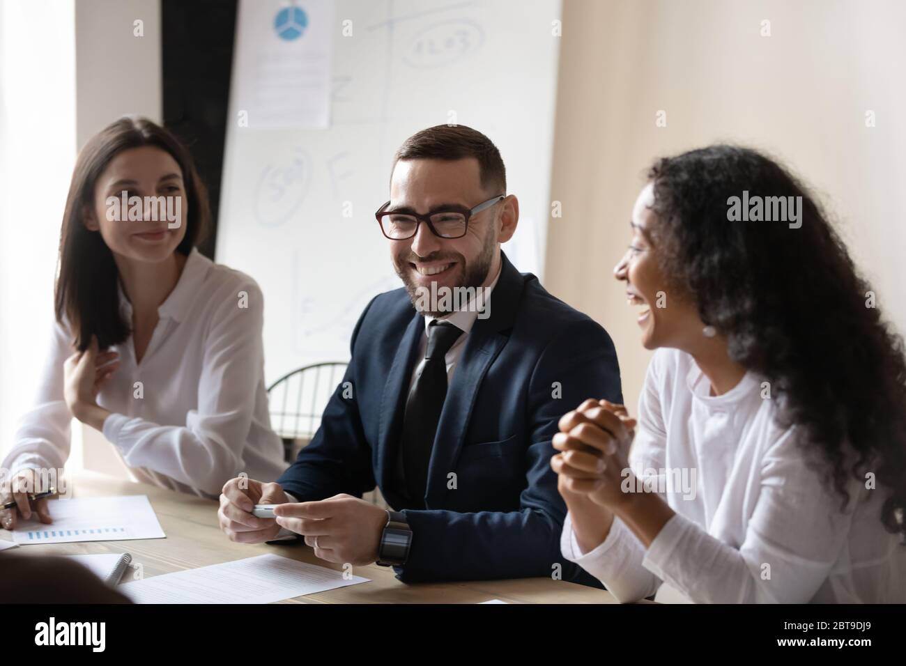 Diverse colleagues laughing at funny joke at corporate meeting Stock ...