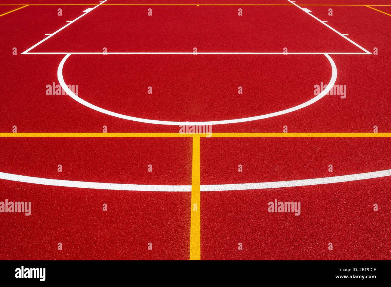 Abstract, red background of newly made outdoor basketball court in park ...