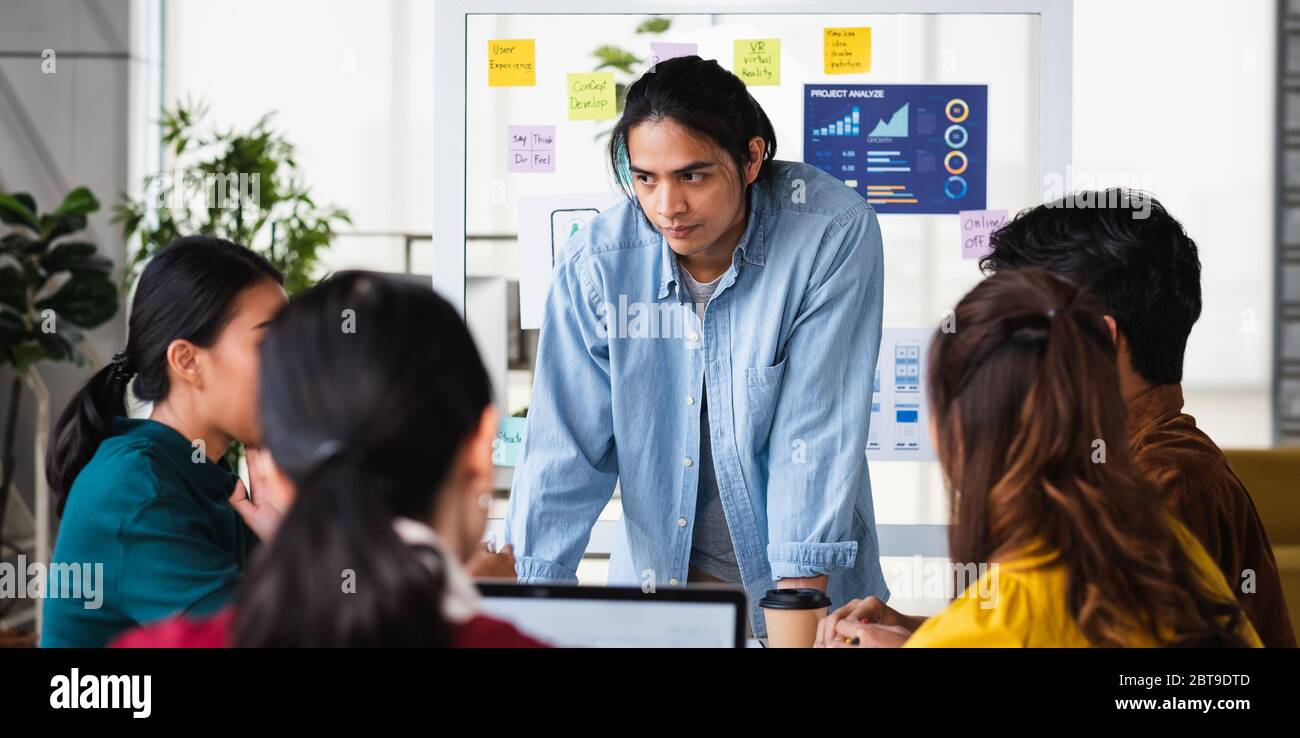 Asian Ux Developer And Ui Designer Brainstorming About Mobile App