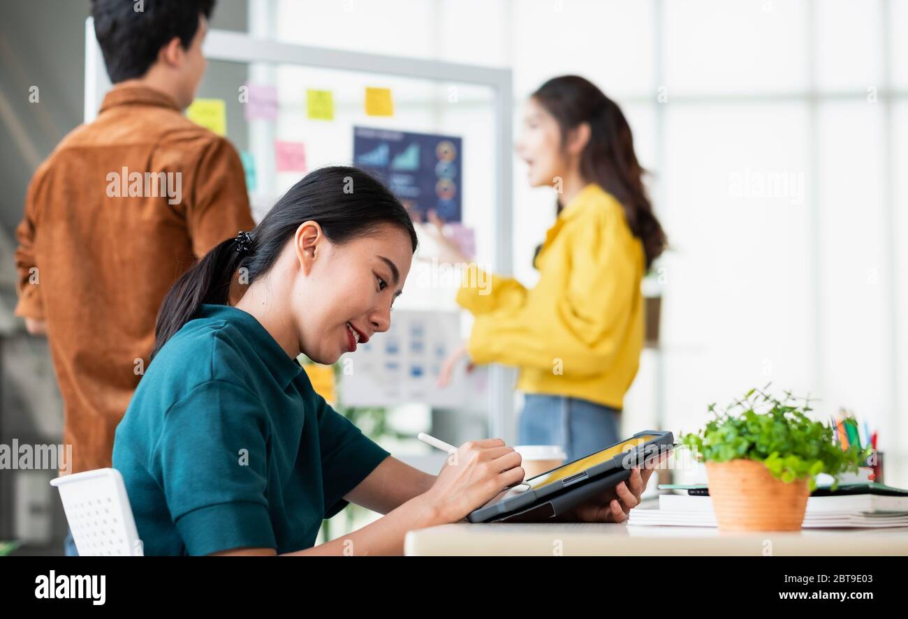 Asian Ux Developer And Ui Designer Using Tablet Testing Mobile App Interface Design With