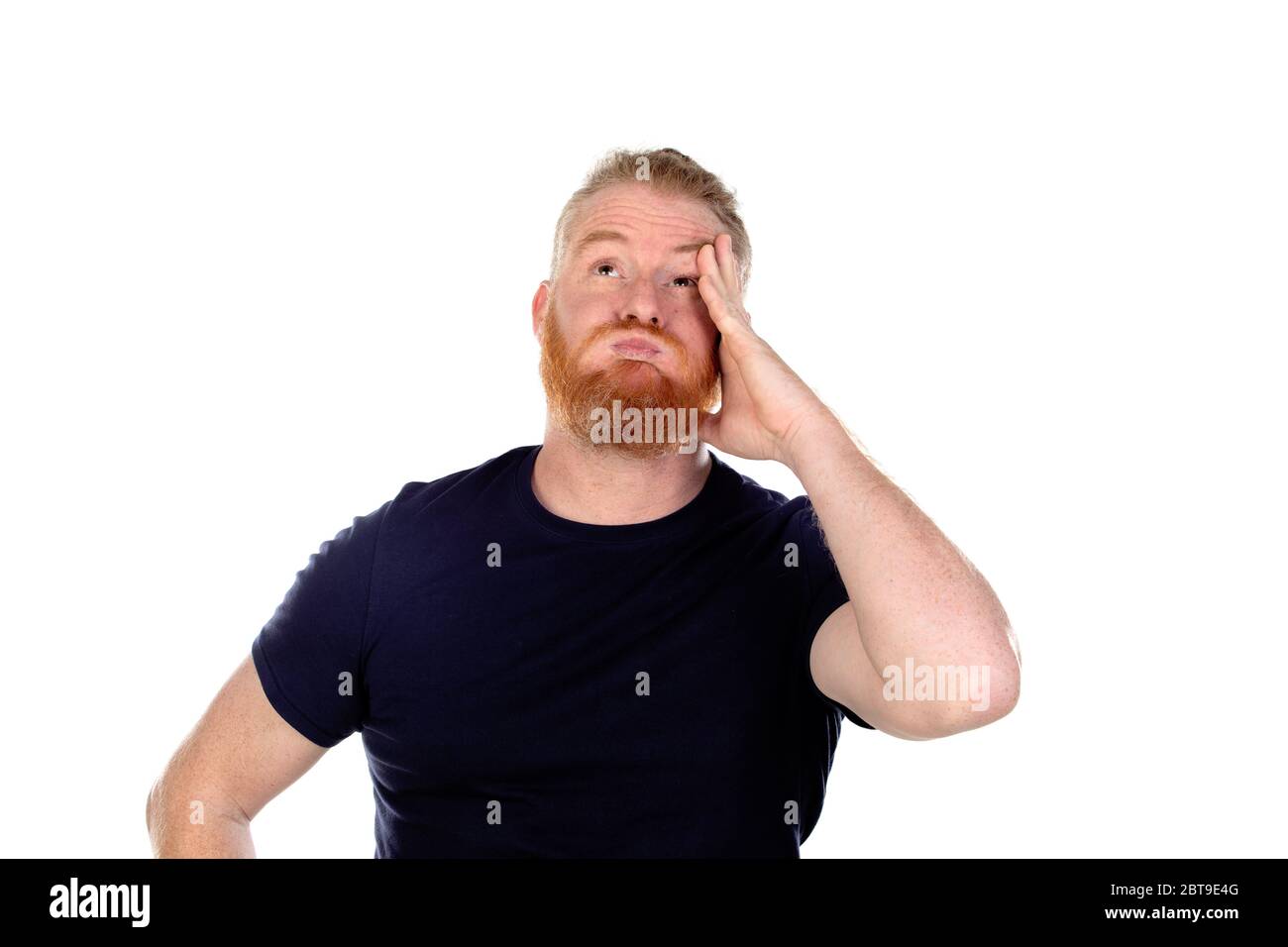 Red haired man with long beard thinking isolated on a white background ...