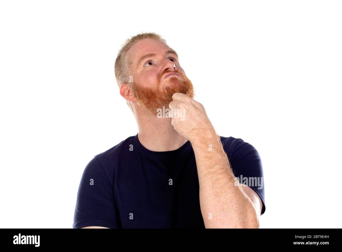 Red haired man with long beard thinking isolated on a white background ...