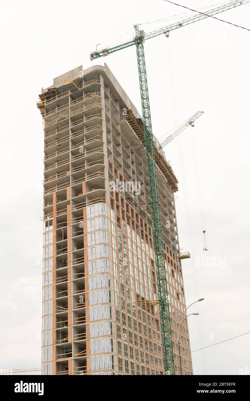 The stopped construction of a high-rise building. Unfinished floors of ...
