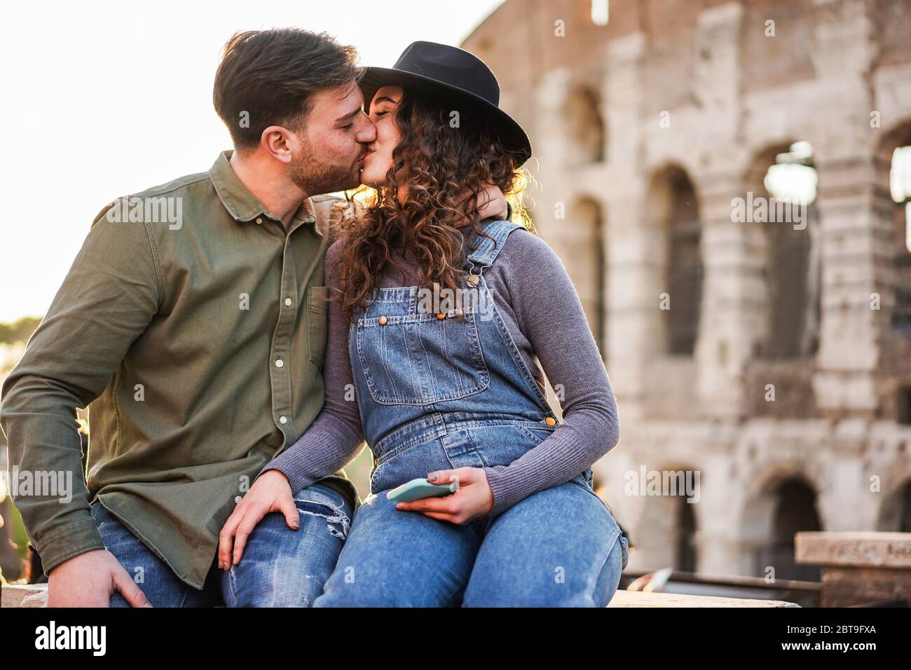 Young couple having tender moments in Rome with Colosseum as background ...