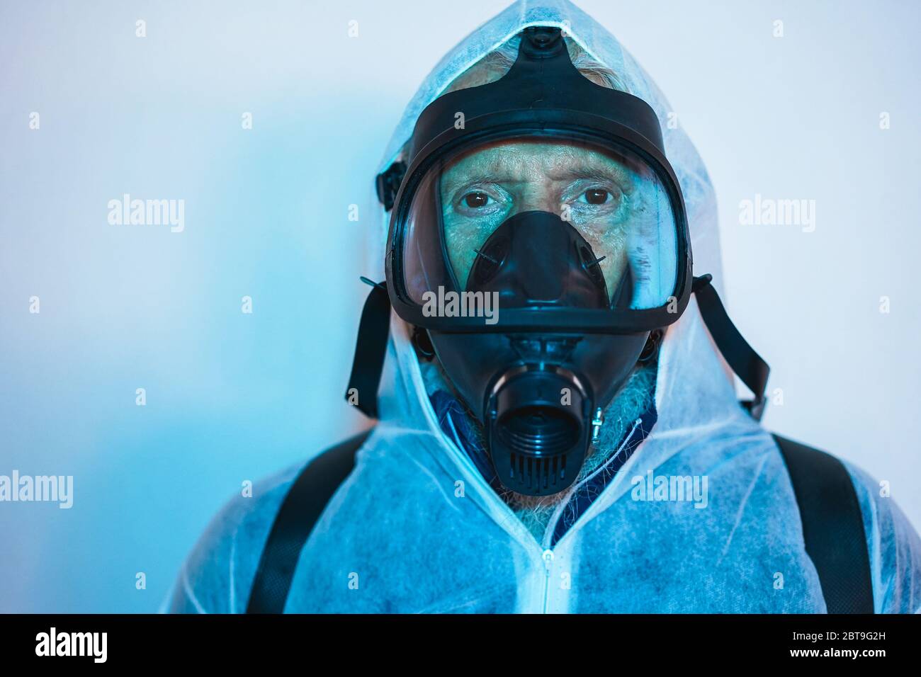 Worker in hazmat suit wearing face gas mask protection while making ...