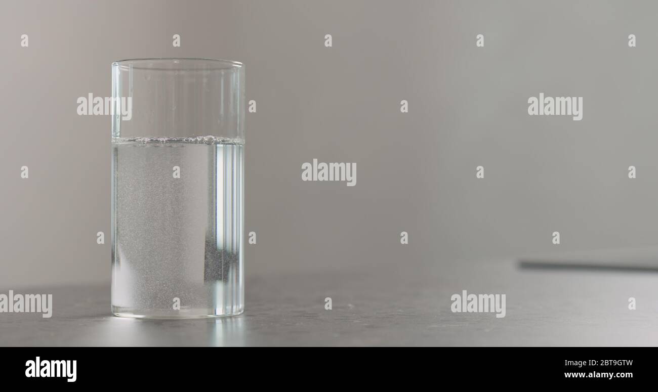 clean fresh water in beaker glass on concrete countertop Stock Photo ...