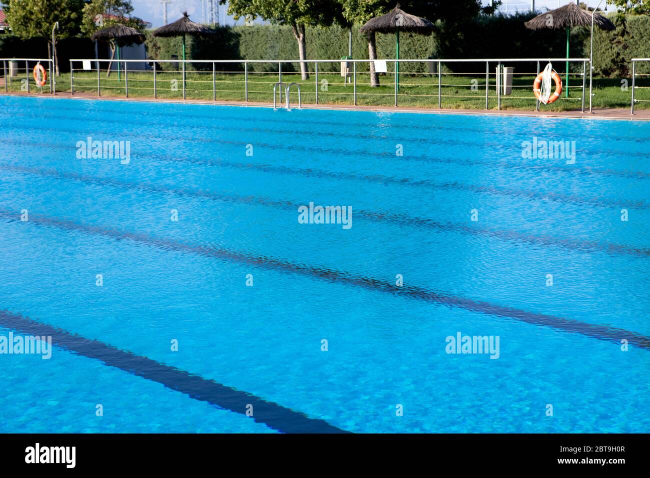 Lonely olympic pool with a blue water ready to swim Stock Photo - Alamy