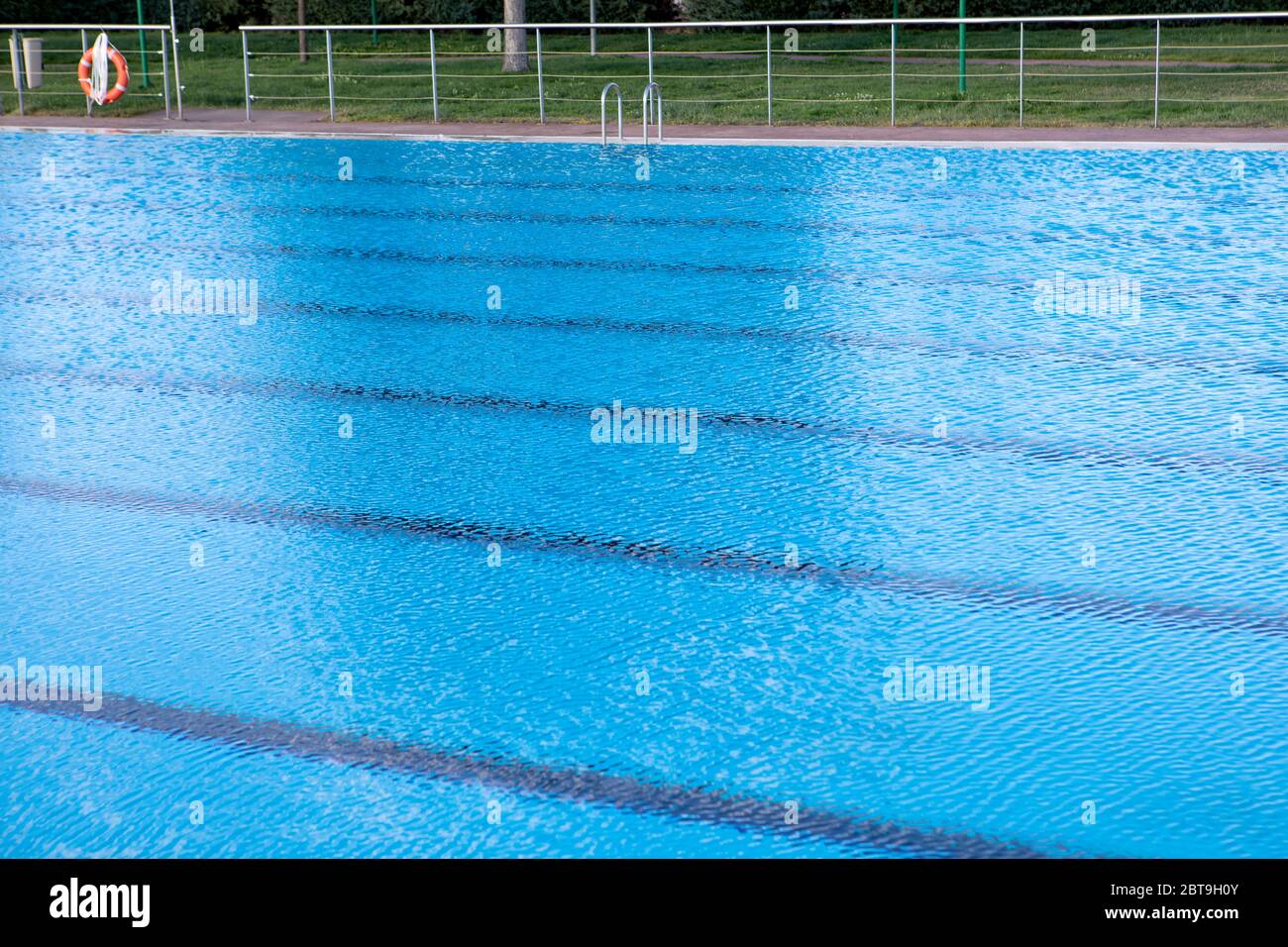 Lonely olympic pool with a blue water ready to swim Stock Photo - Alamy