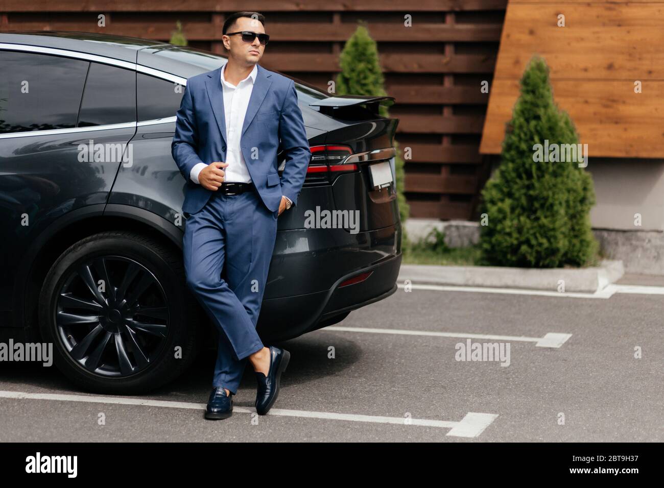 Elegant man in the suit standing near the car Stock Photo - Alamy