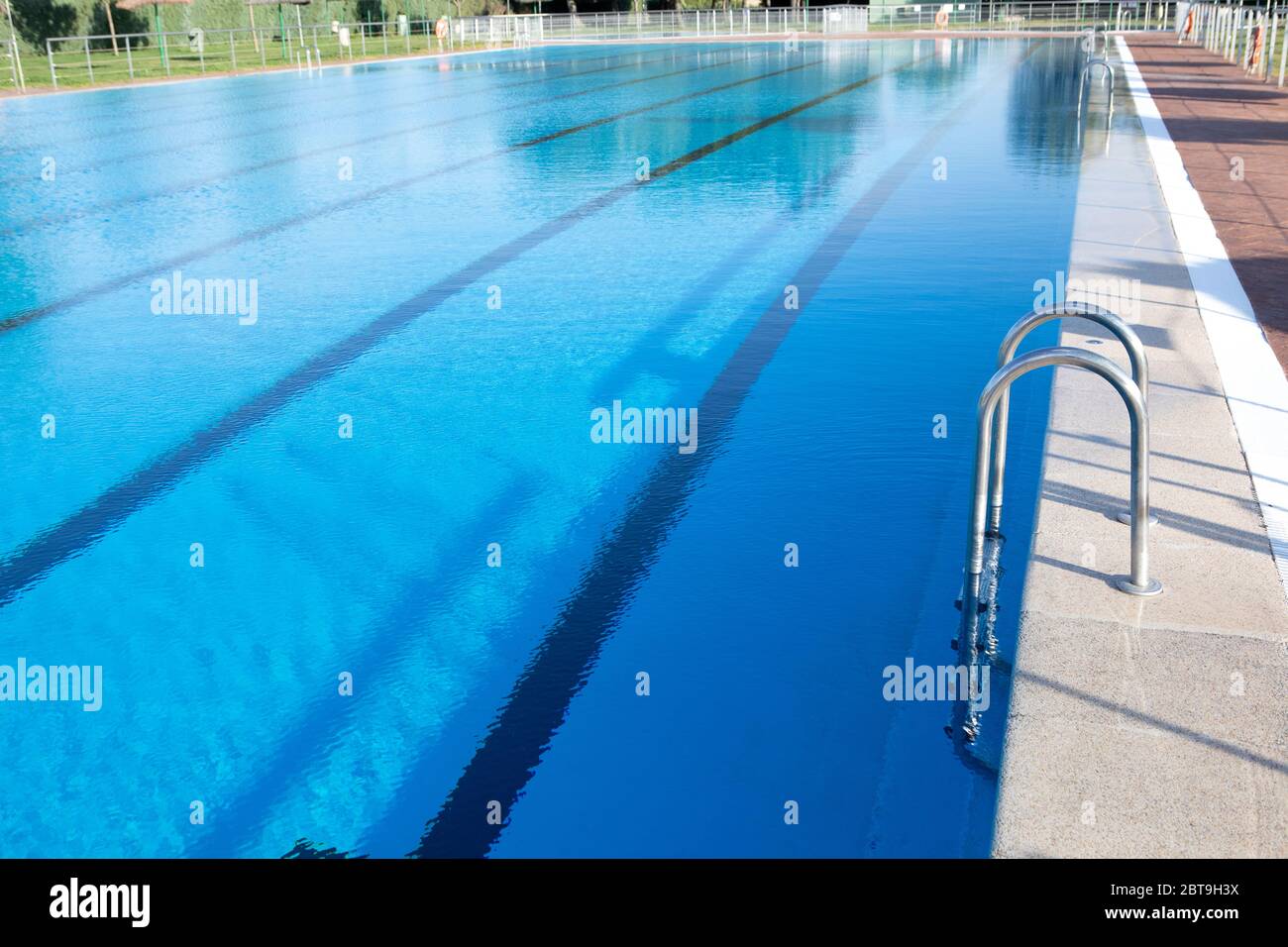 Lonely olympic pool with a blue water ready to swim Stock Photo - Alamy