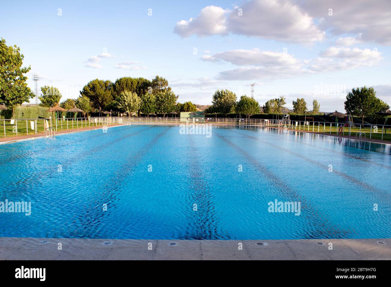 Sunny swimming pool with blue water ready to swim Stock Photo - Alamy