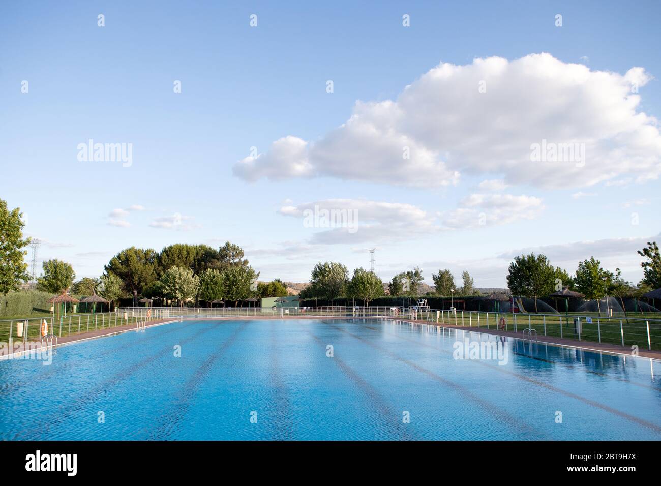 Sunny swimming pool with blue water ready to swim Stock Photo - Alamy