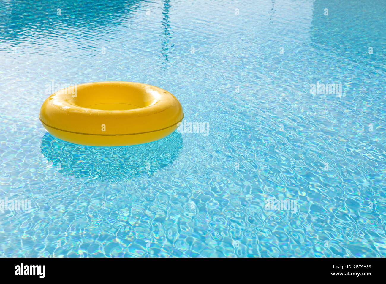 Yellow big float on pool with a blue water ready to swim Stock Photo ...