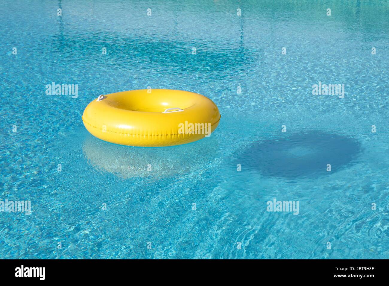 Yellow big float on pool with a blue water ready to swim Stock Photo ...