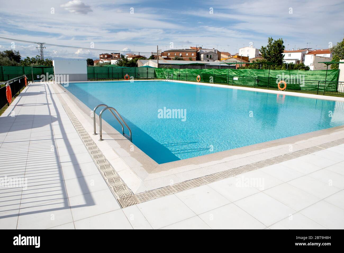 Sunny swimming pool with blue water ready to swim Stock Photo - Alamy