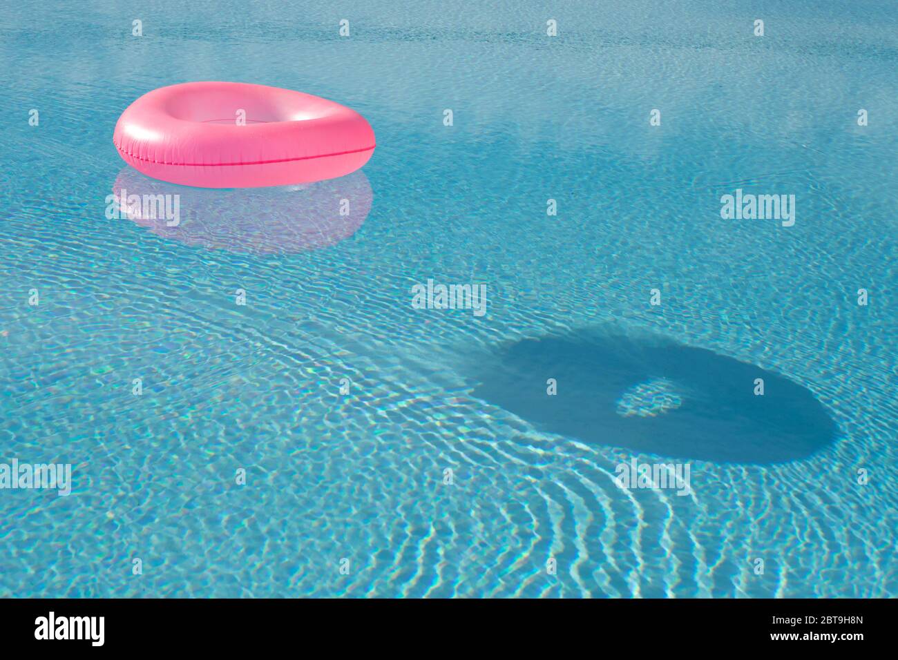 Pink big float on pool with a blue water ready to swim Stock Photo - Alamy