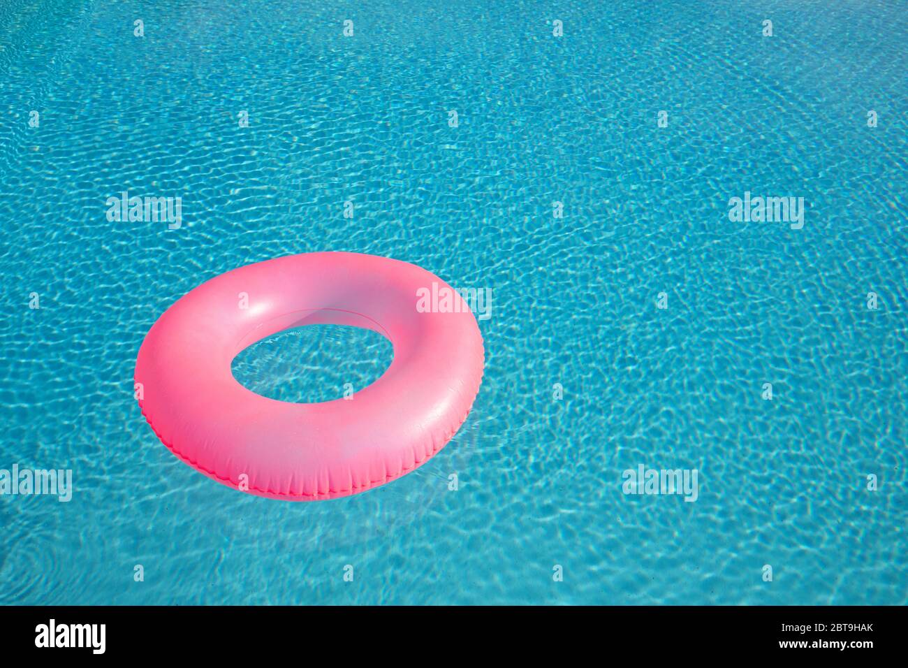 Pink big float on pool with a blue water ready to swim Stock Photo - Alamy