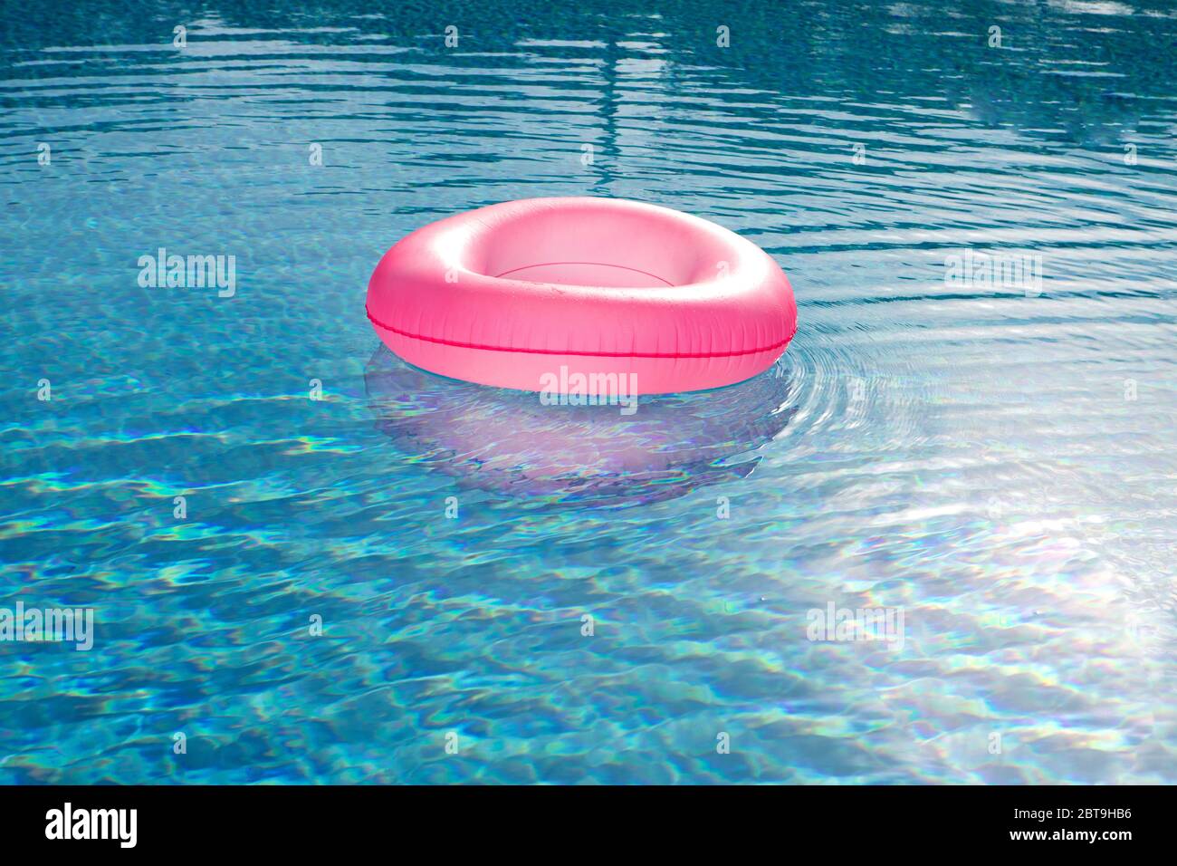 Pink big float on pool with a blue water ready to swim Stock Photo - Alamy