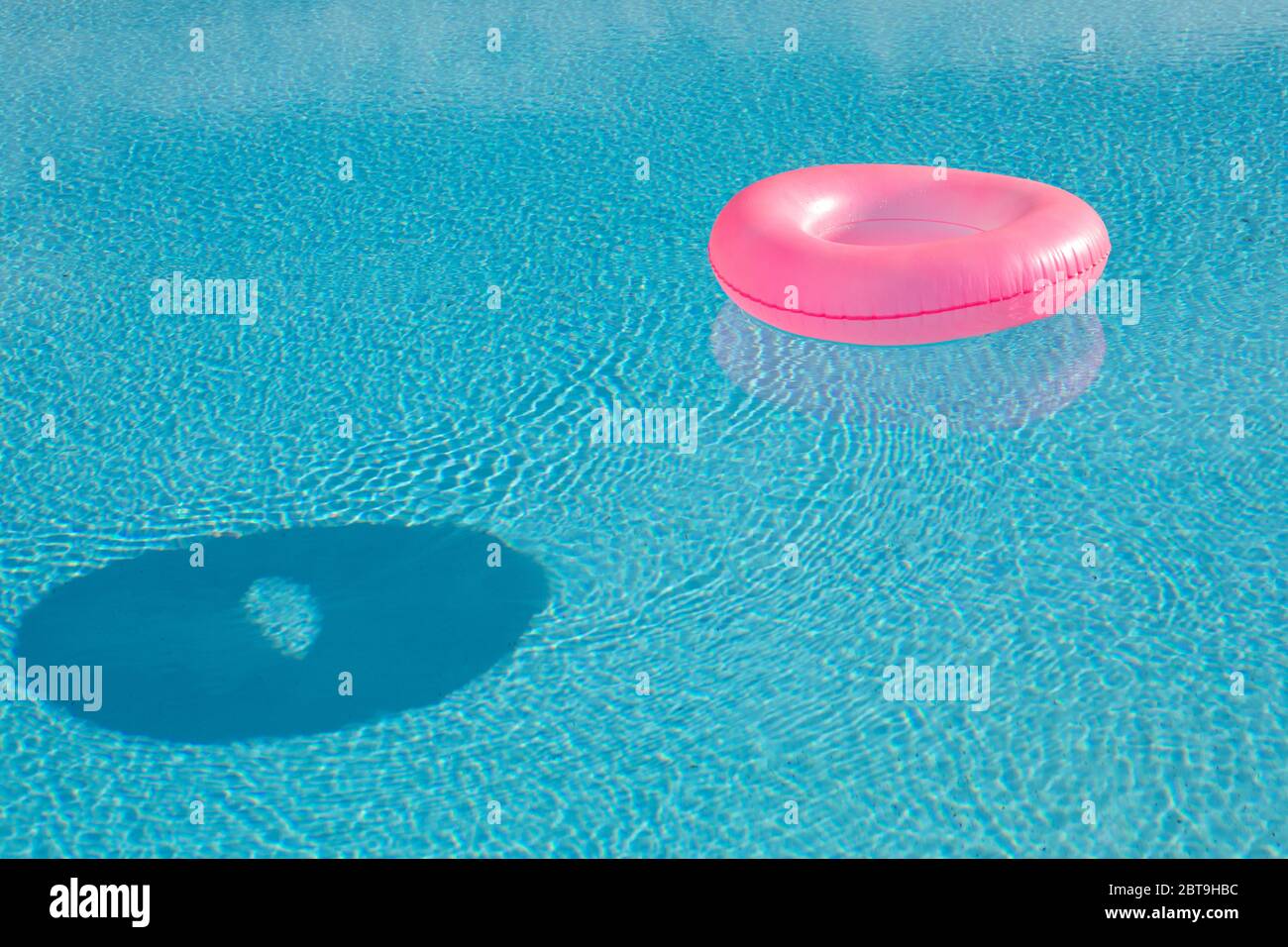 Pink big float on pool with a blue water ready to swim Stock Photo - Alamy