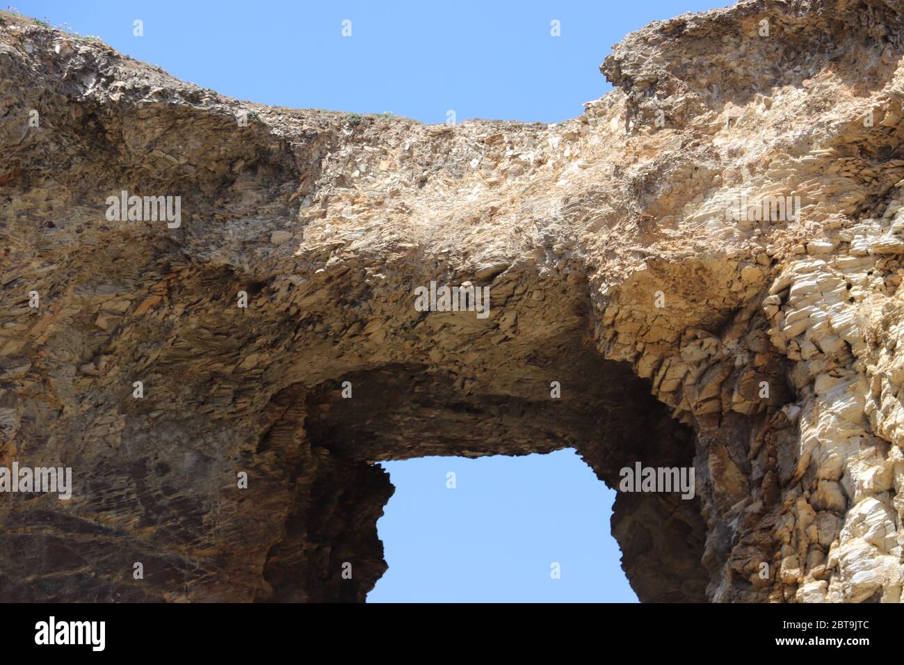 Close up of rocky arch with blue sky Stock Photo - Alamy