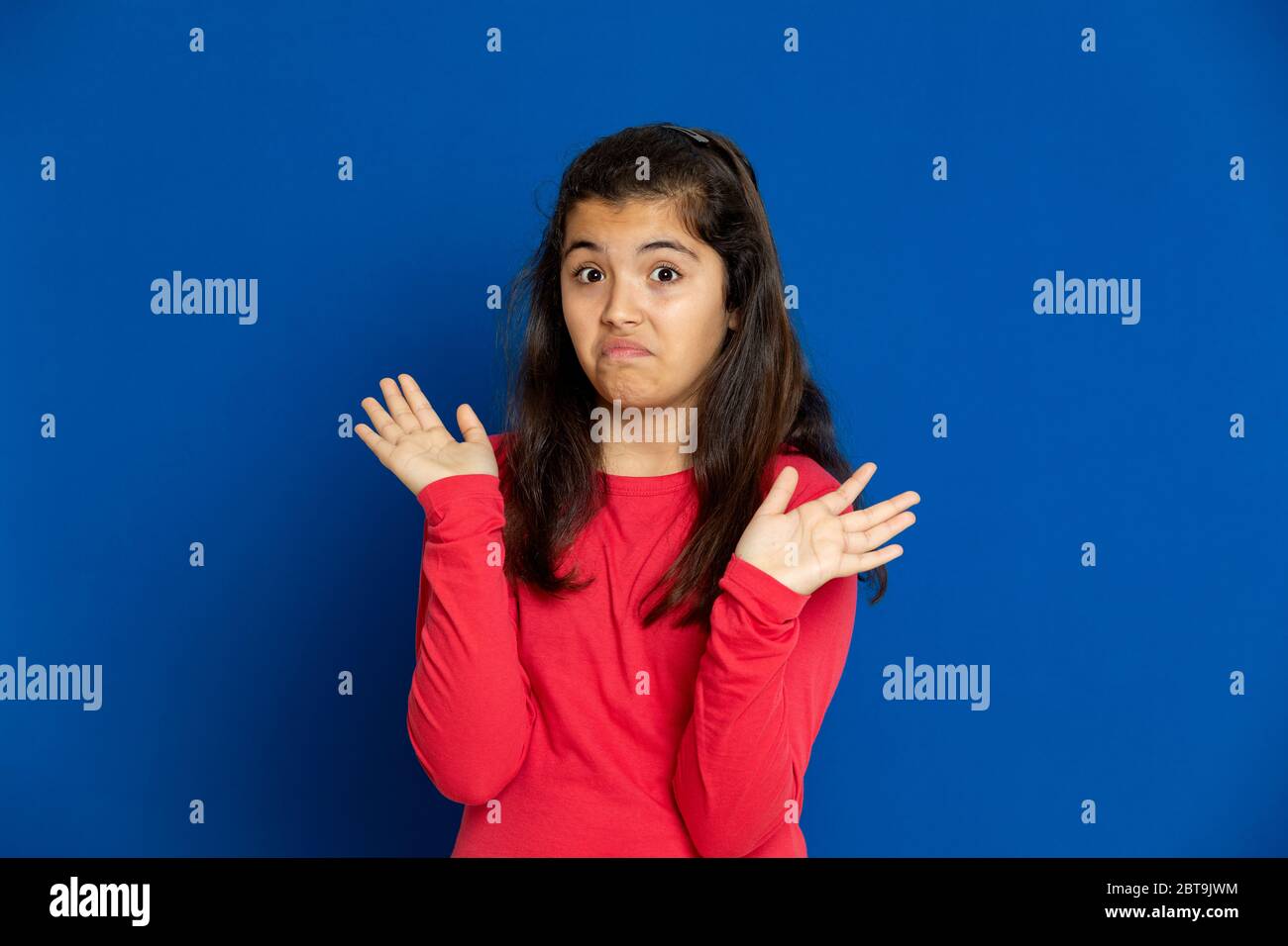 Adorable preteen girl with red t-shirt i on a blue background Stock ...