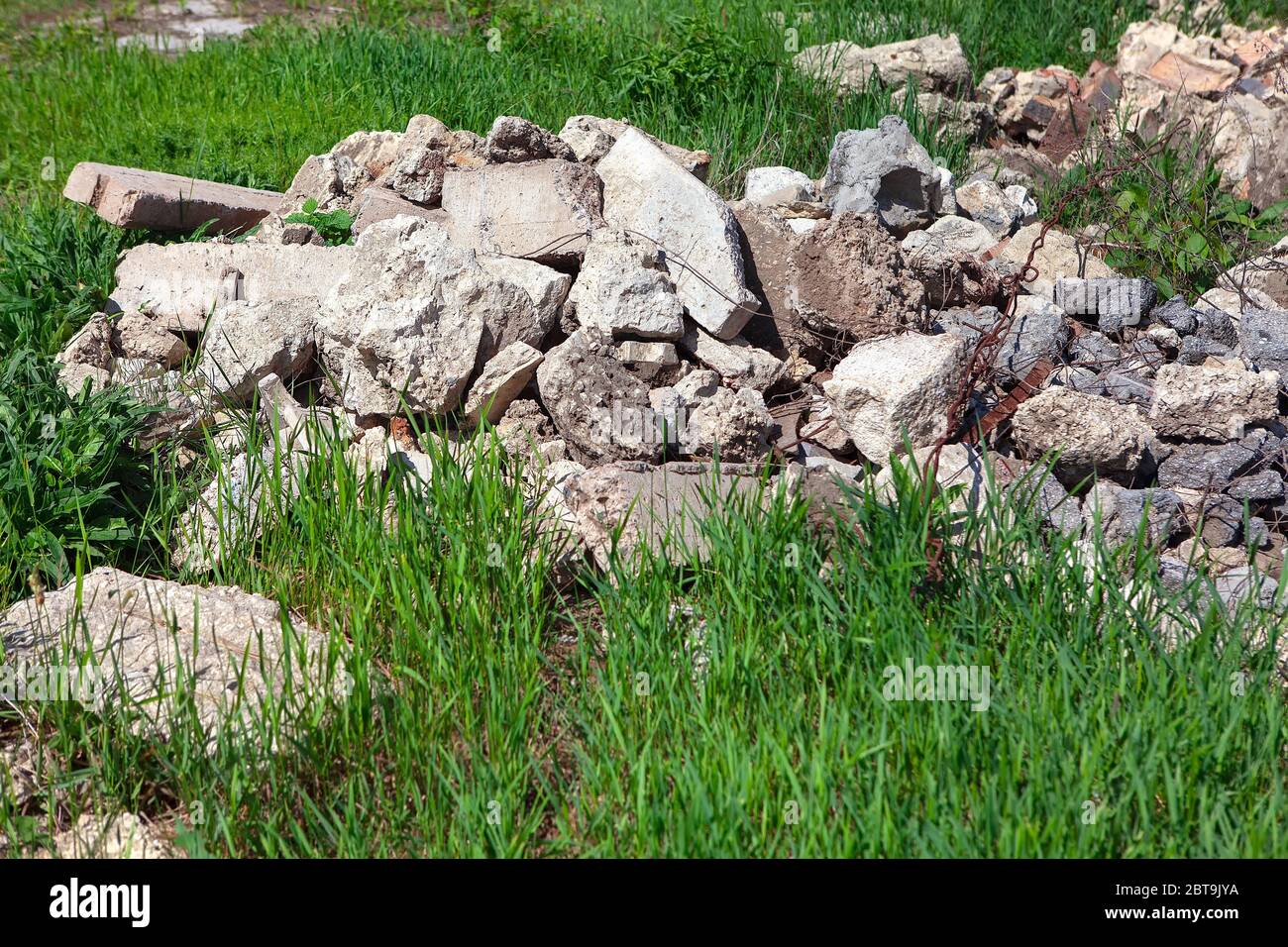 construction stones waste in the green grass Stock Photo - Alamy