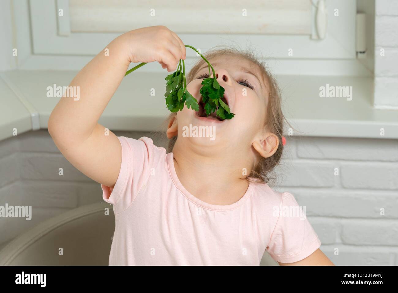 3-5 year old child eats a sprig of parsley. children and vegetarianism ...