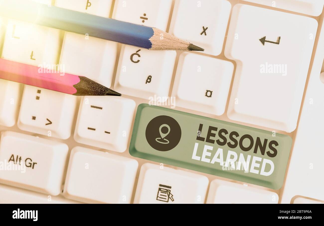 Writing note showing Lessons Learned. Business concept for the knowledge or understanding gained ...