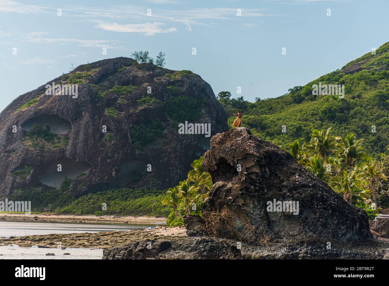 Fijian island inhabitant dancing on a rock in the sea, close to an ...