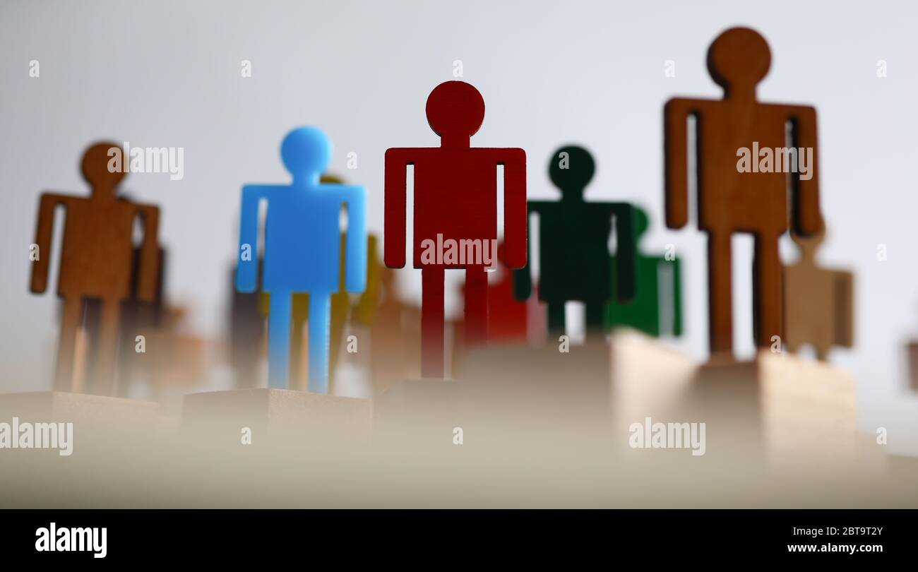 Plastic or wooden colored figures people team Stock Photo - Alamy