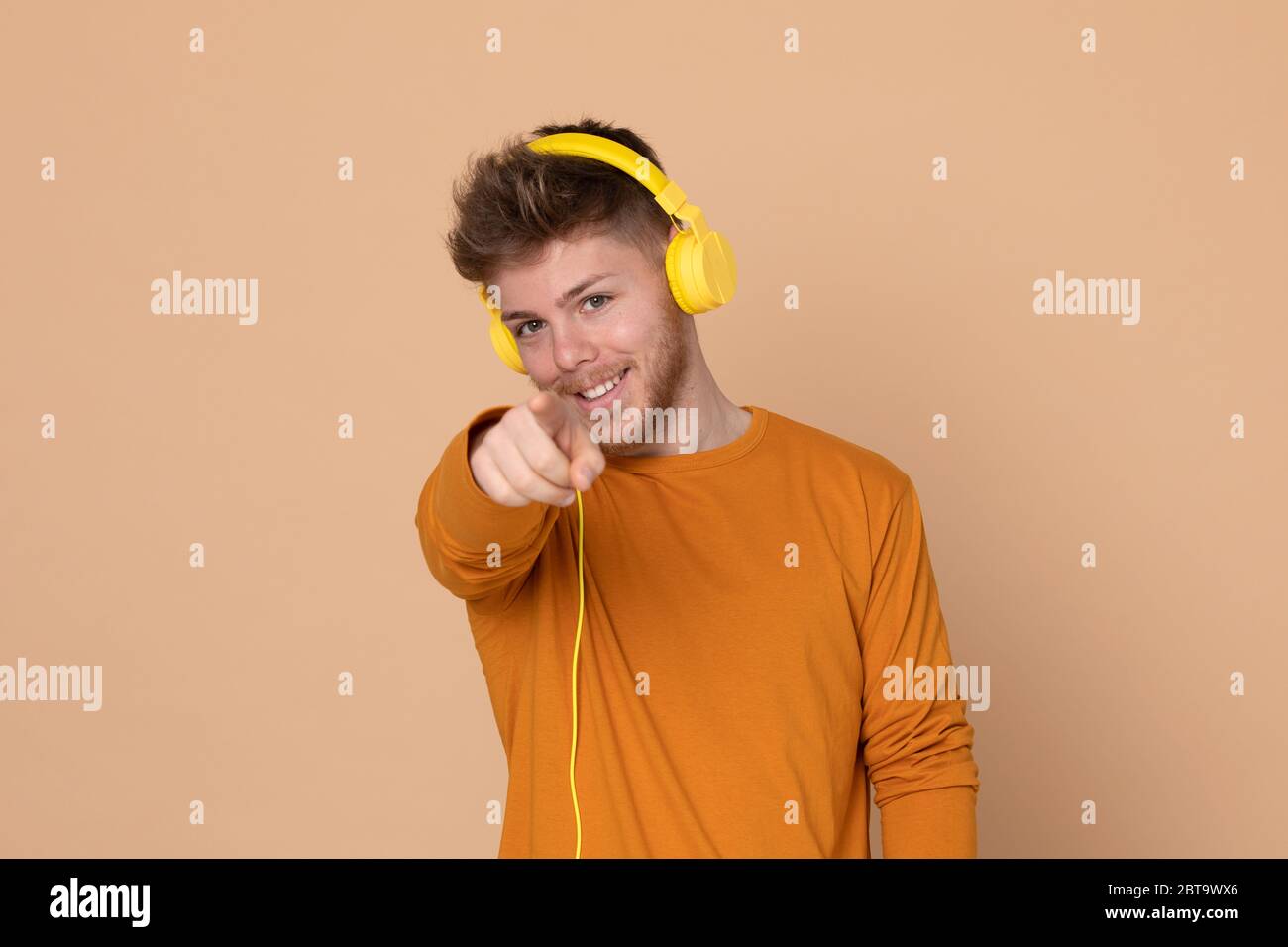 Attractive young guy on a yellow background Stock Photo - Alamy