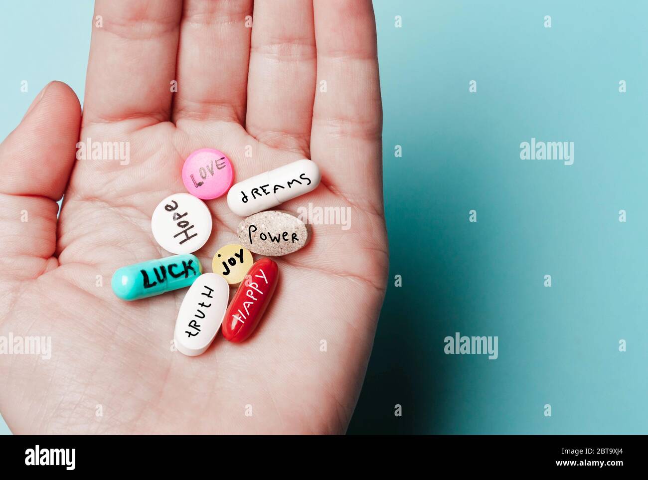 The concept of creative pills, a placebo in the hand, with joy, love ...
