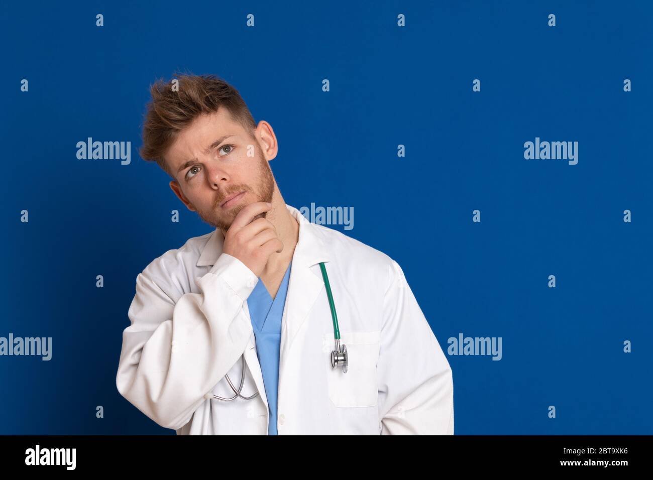 Attractive doctor with white lab coat on a blue background Stock Photo ...