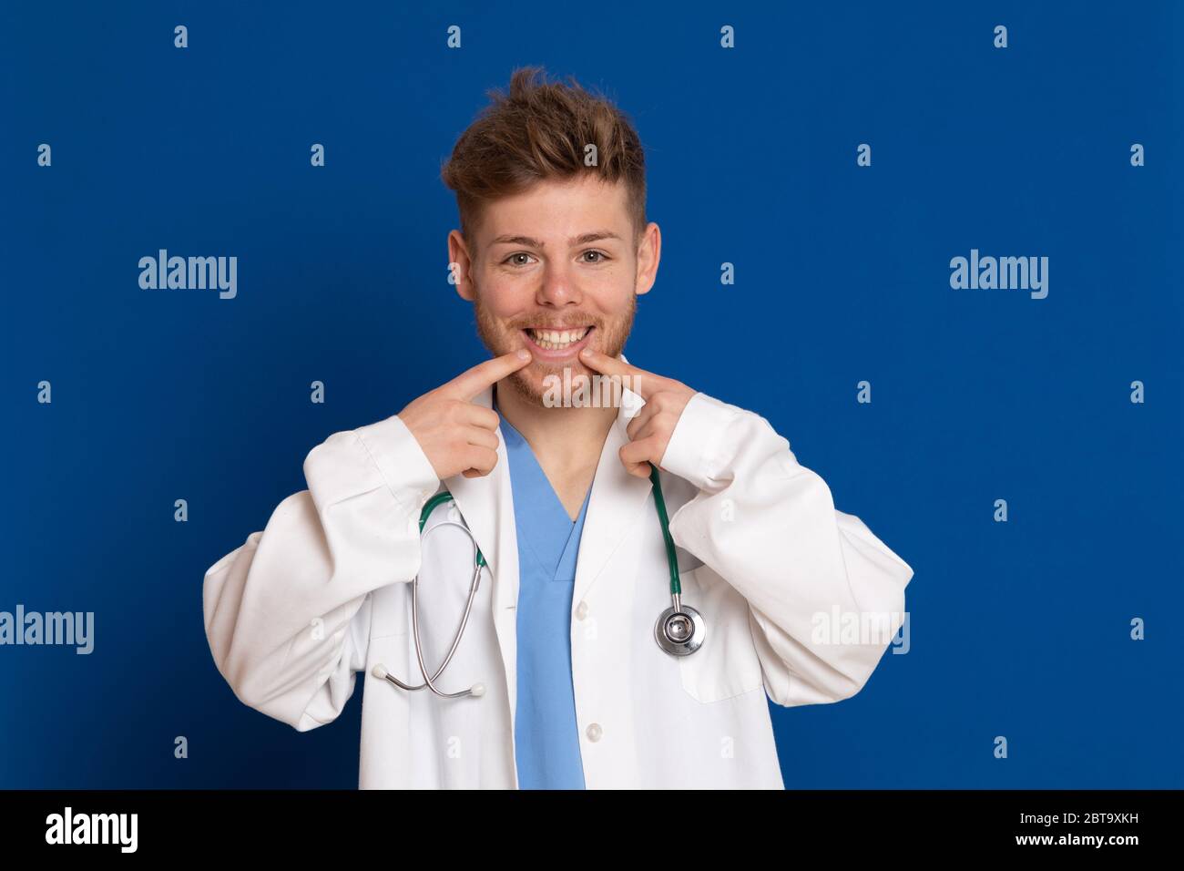 Doctor wearing a white lab coat on a blue background Stock Photo - Alamy