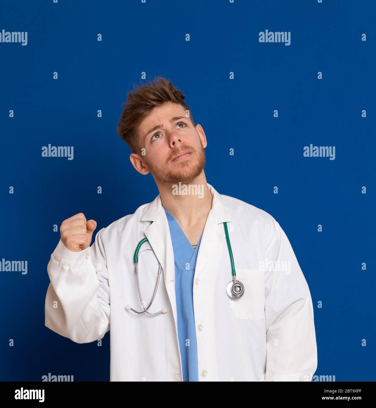 Doctor wearing a white lab coat on a blue background Stock Photo - Alamy