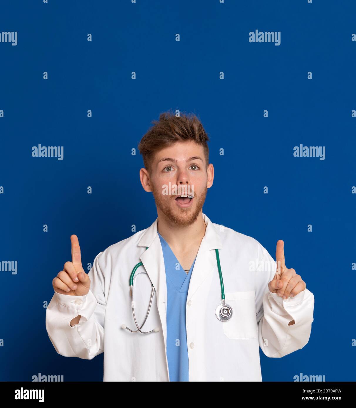 Doctor wearing a white lab coat on a blue background Stock Photo - Alamy