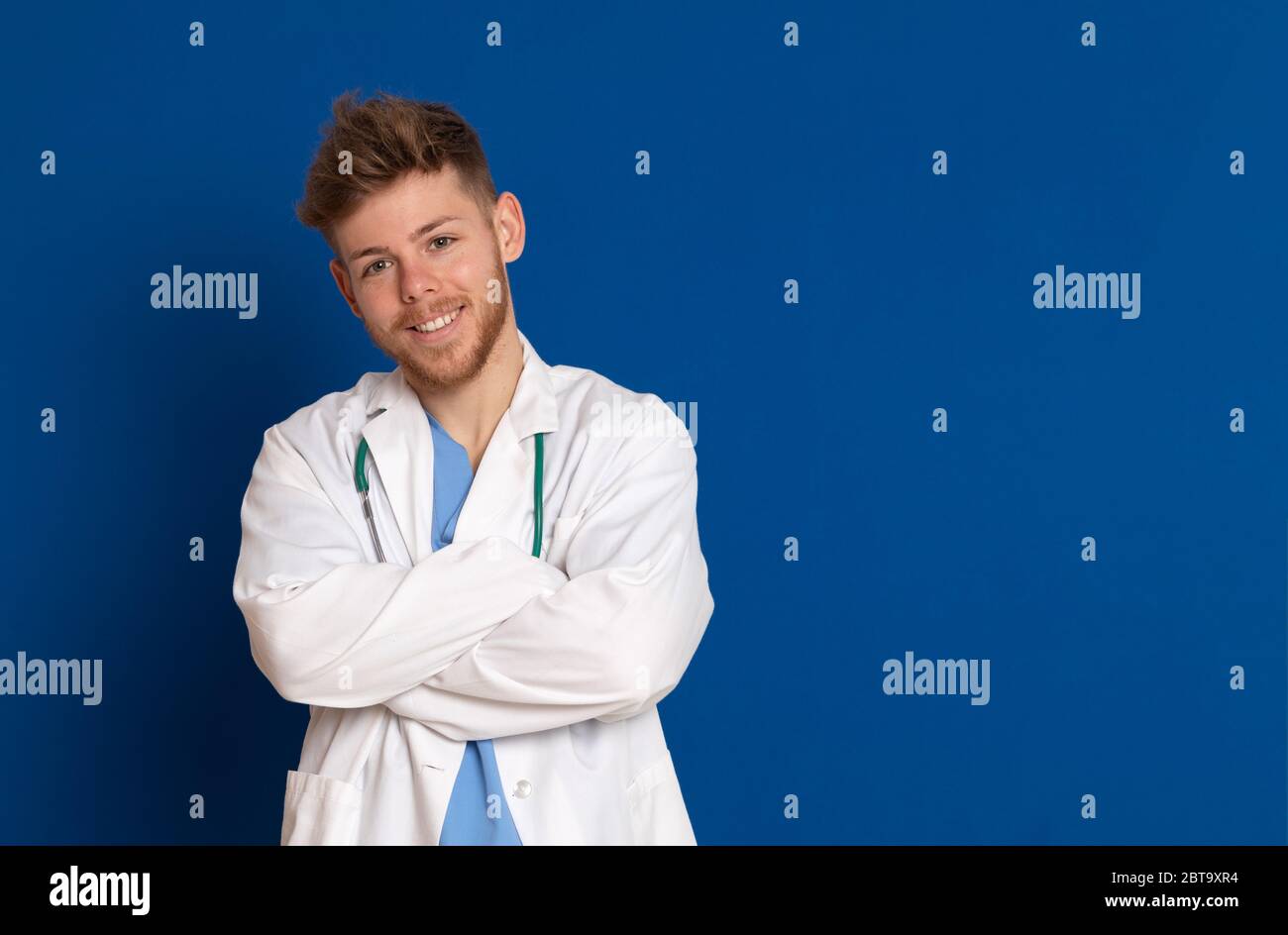 Doctor wearing a white lab coat on a blue background Stock Photo - Alamy