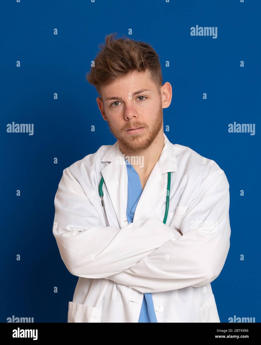 Doctor wearing a white lab coat on a blue background Stock Photo - Alamy