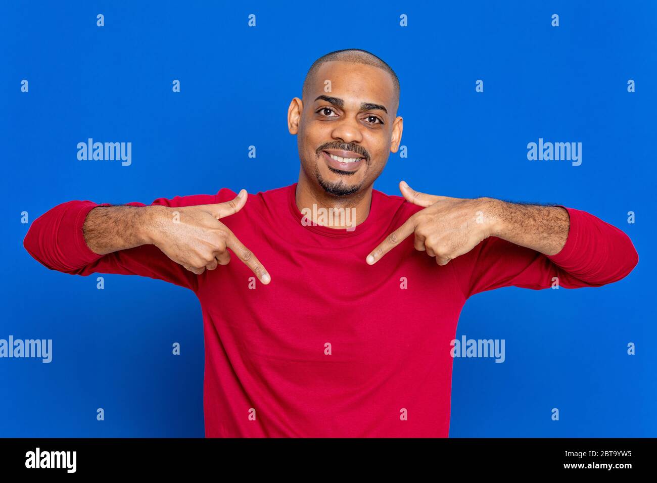 African man with red T-shirt on a blue background Stock Photo - Alamy
