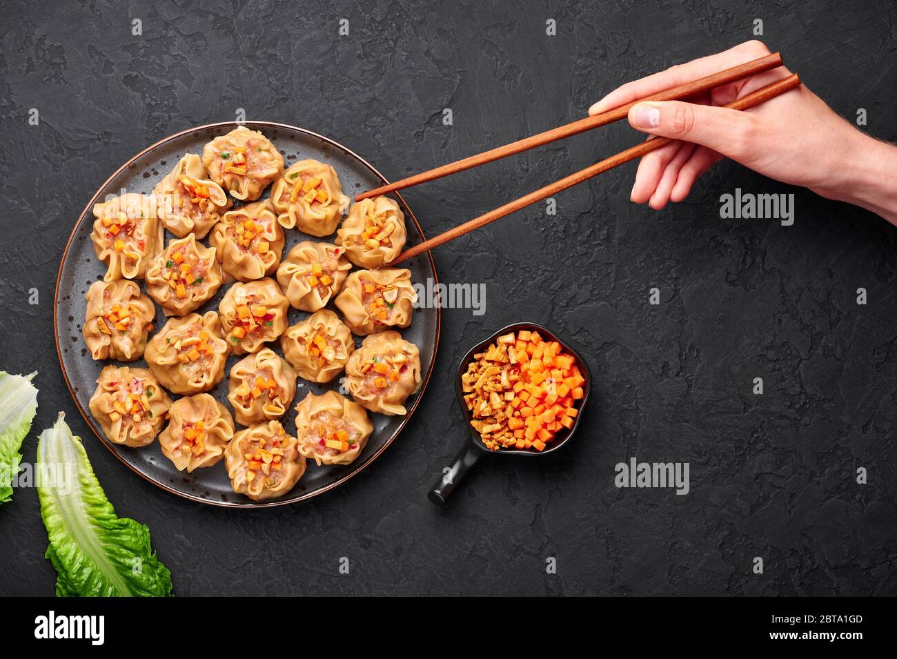 Shumai or Kanom Jeeb or Steamed Pork and Shrimp Dumplings on a black ...