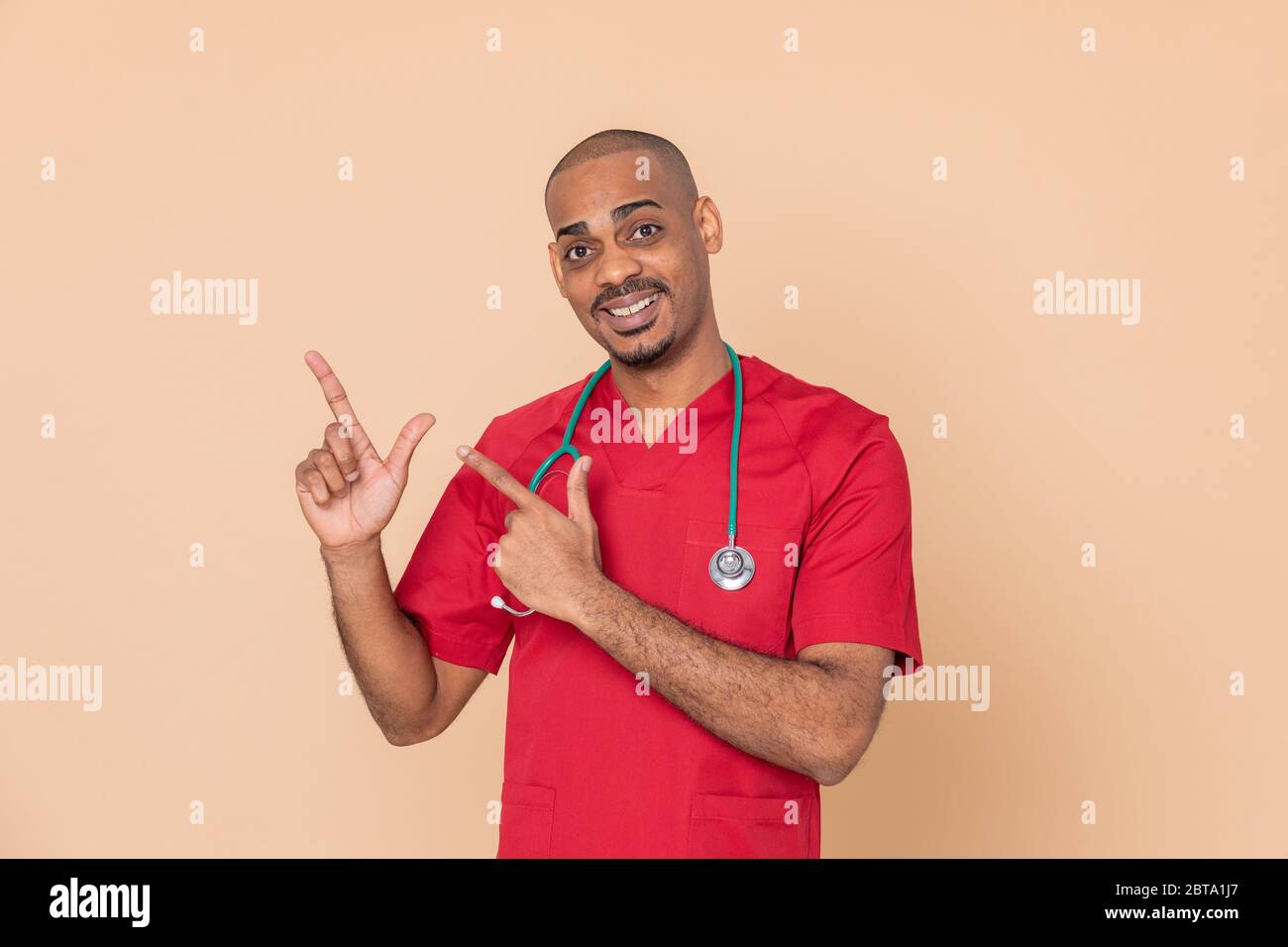 African doctor wearing red uniform on a orange background Stock Photo ...